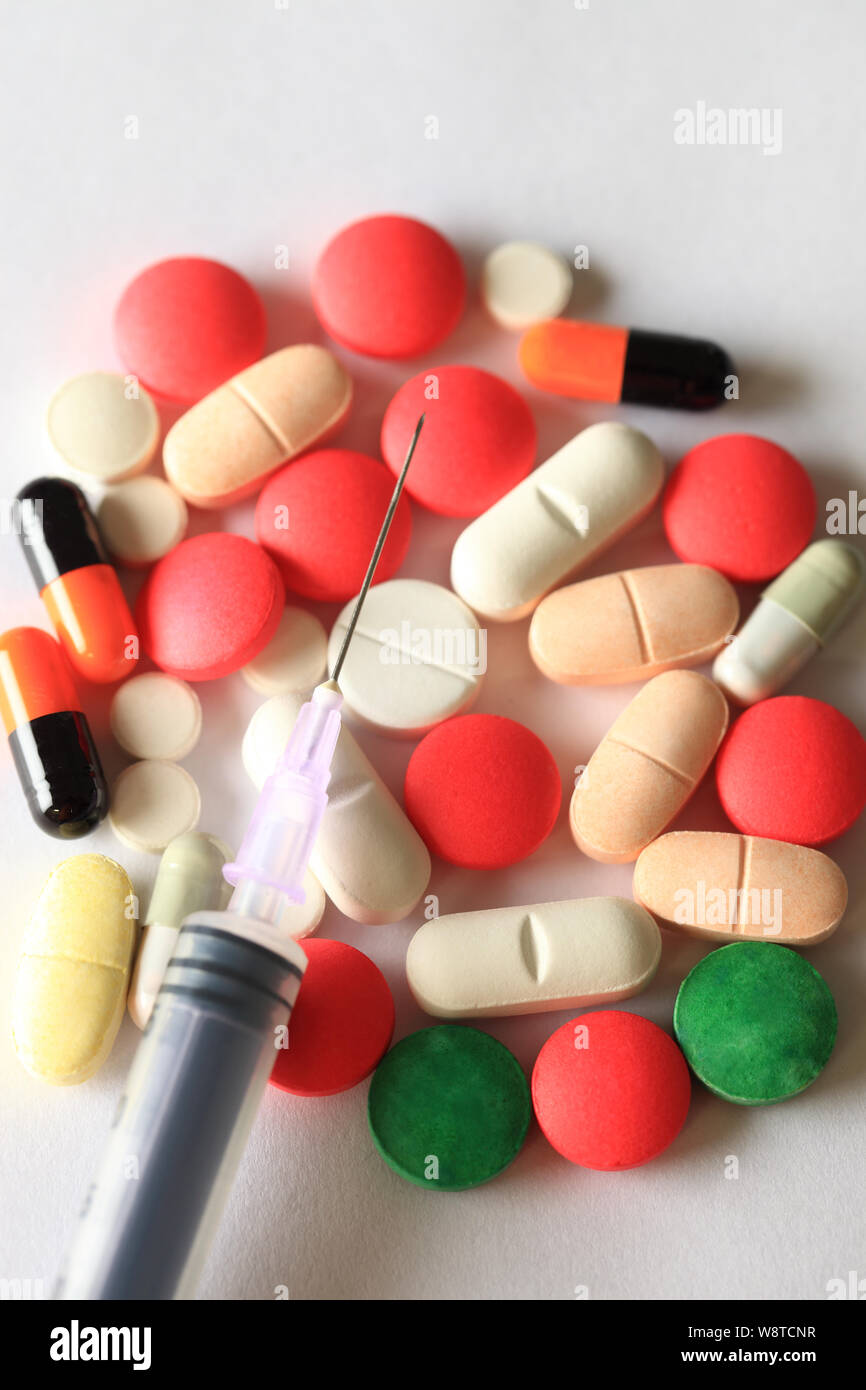 Assorted medicines with a syringe Stock Photo - Alamy