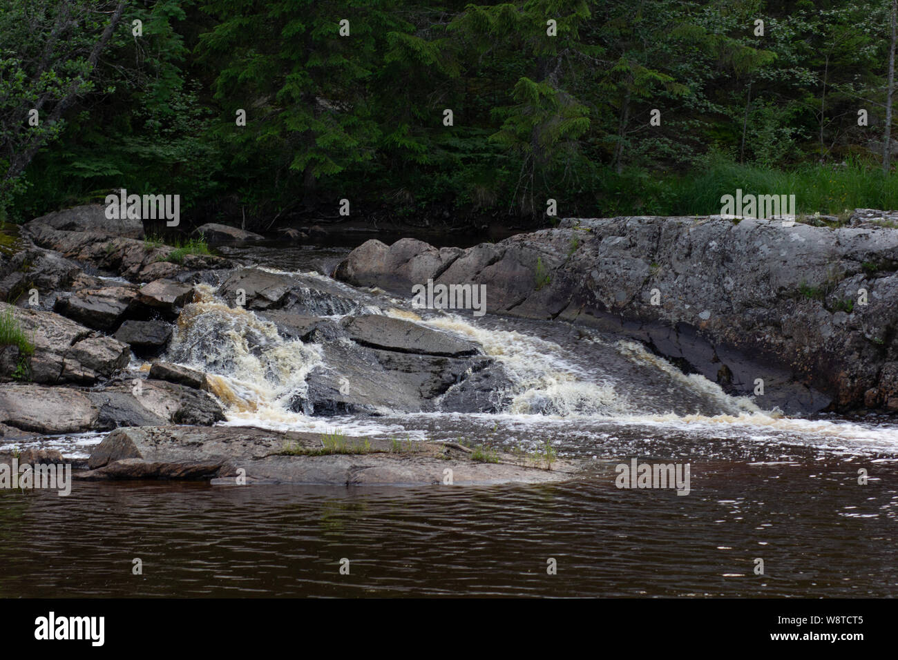 Low waterfall on river in summer forest Stock Photo - Alamy