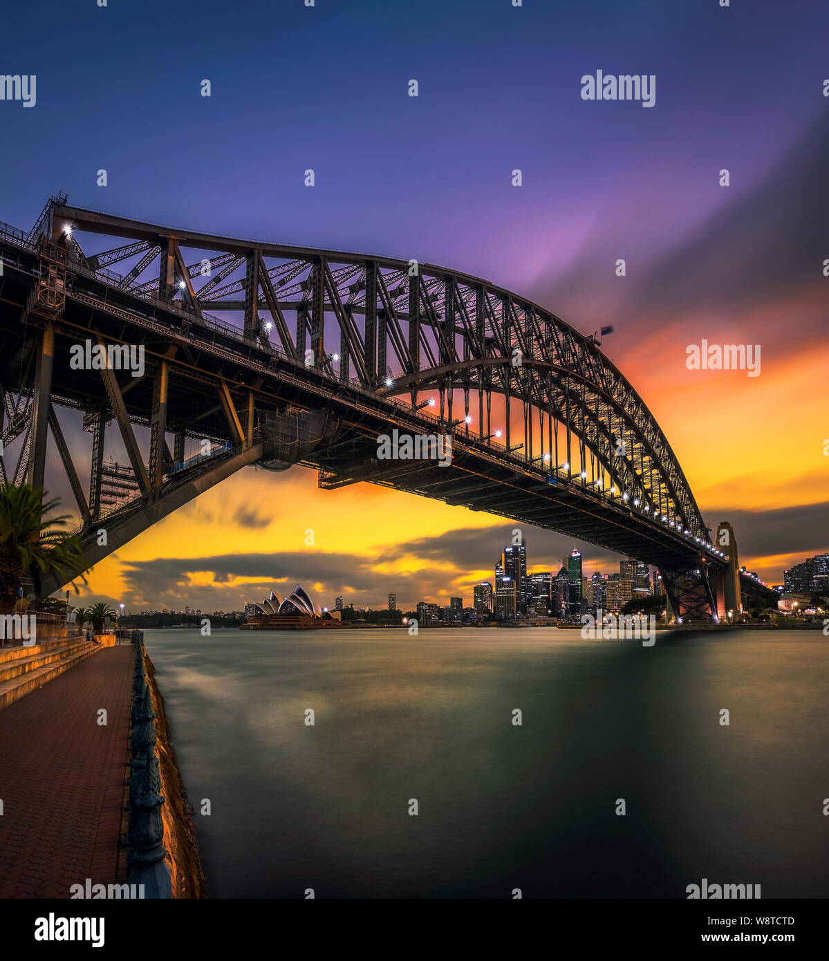 Sunset skyline of Sydney downtown with city lights and Harbour Bridge ...