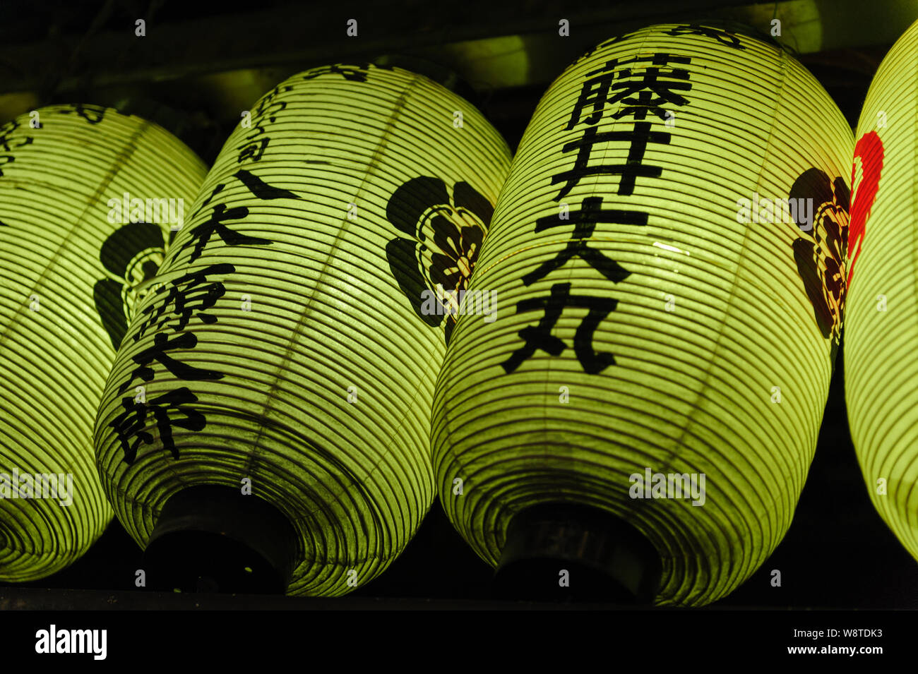 Traditional paper lanterns illuminated during night time delivering an ...