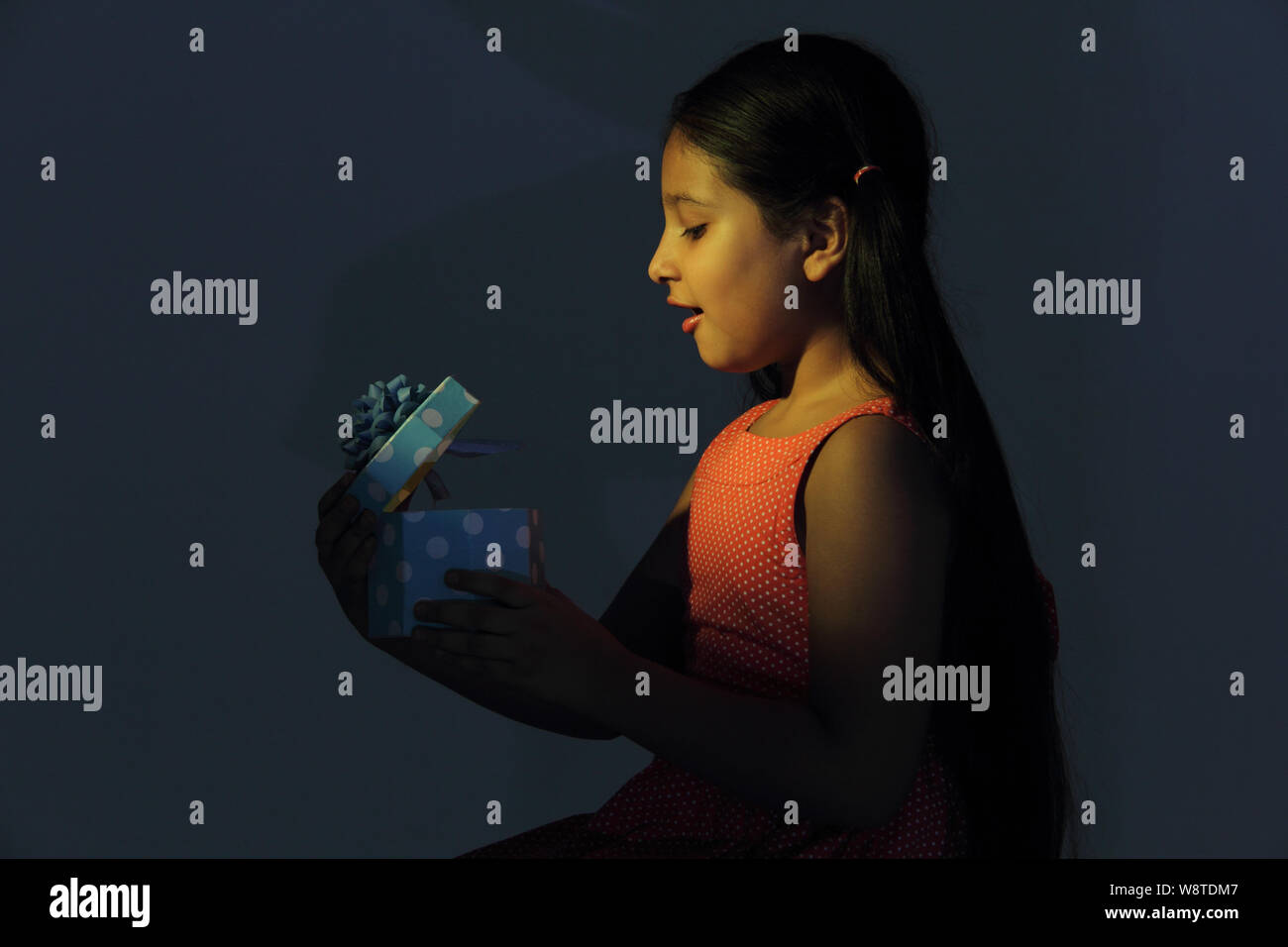 Girl opening a gift box Stock Photo - Alamy