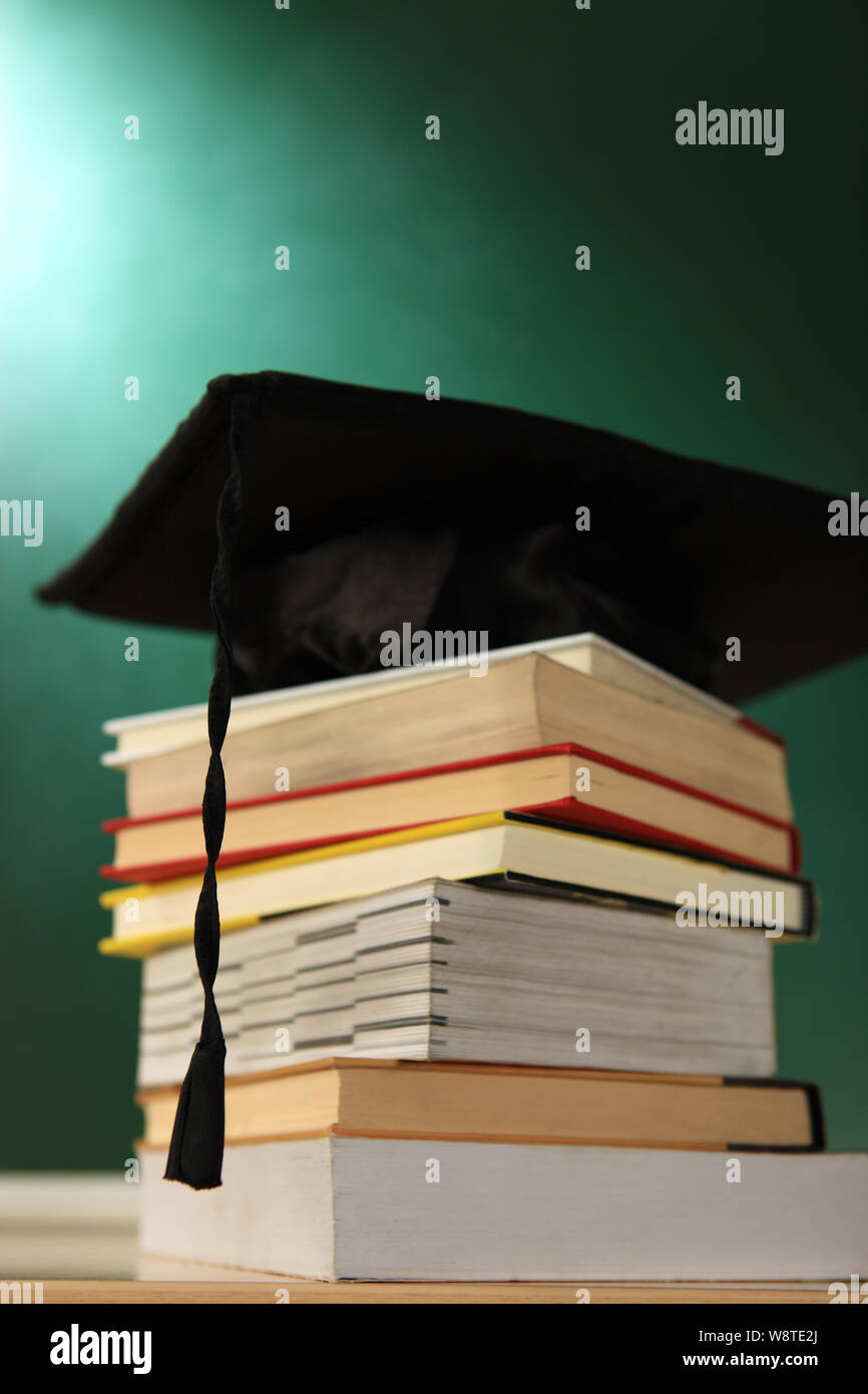 Mortar board on a stack of books Stock Photo - Alamy