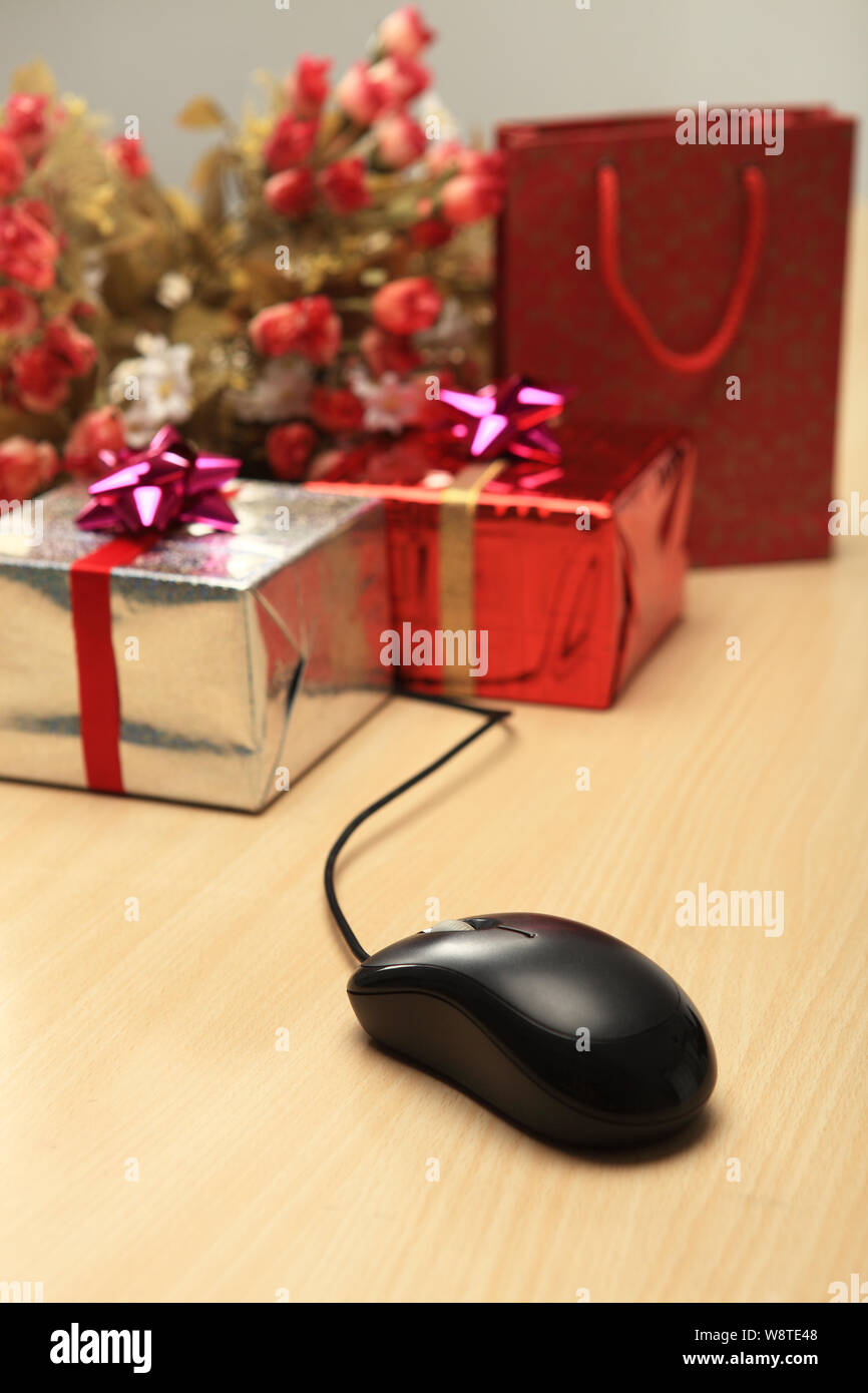 Gift boxes and shopping bag connected with a computer mouse Stock Photo ...