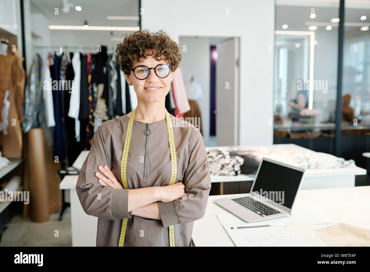 Young successful fashion designer on background of casualwear ...