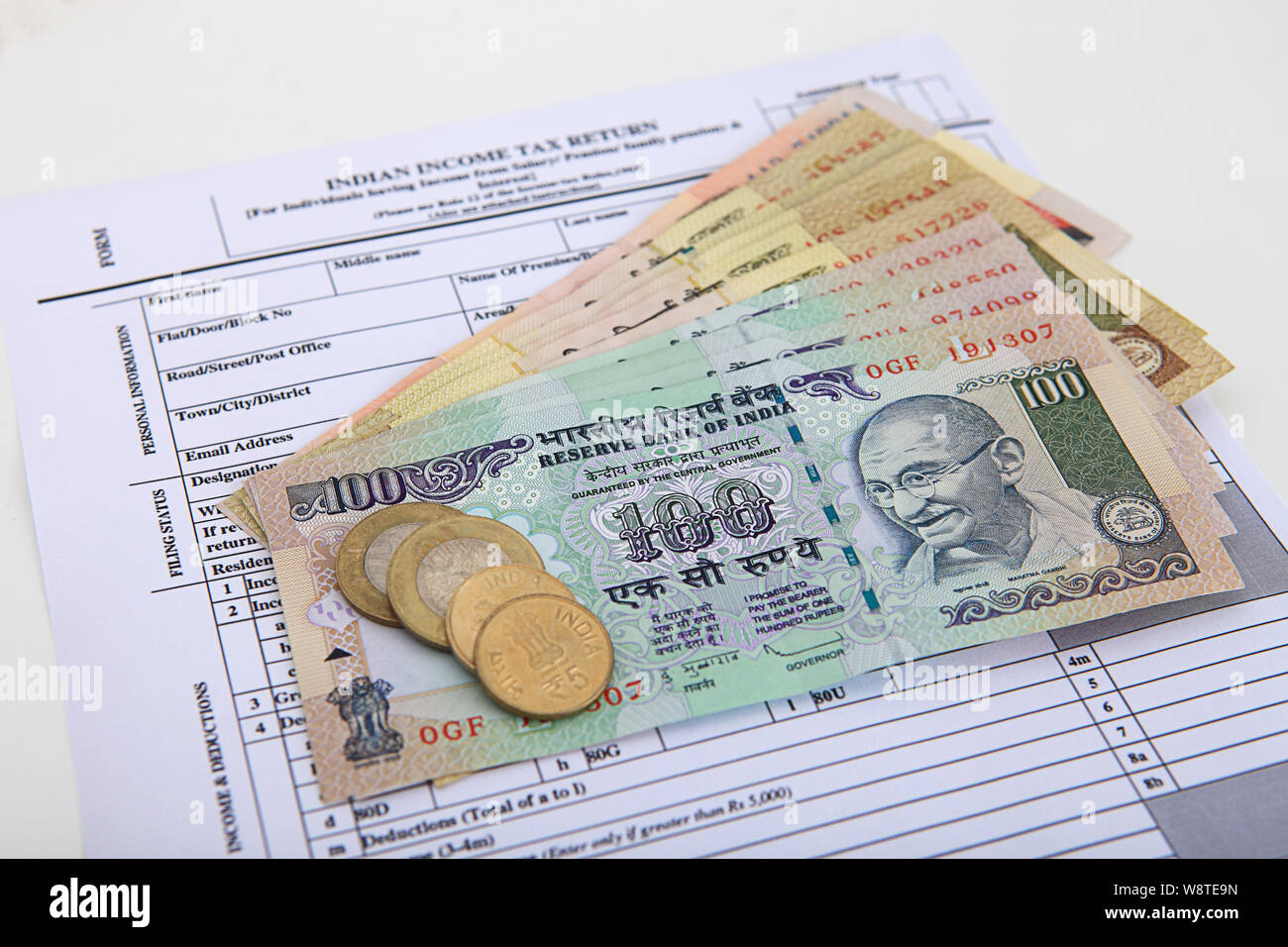 Indian currency on an income tax return form Stock Photo - Alamy