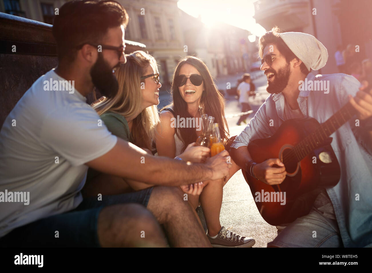 Group of friends having fun and hanging out outdoors Stock Photo - Alamy