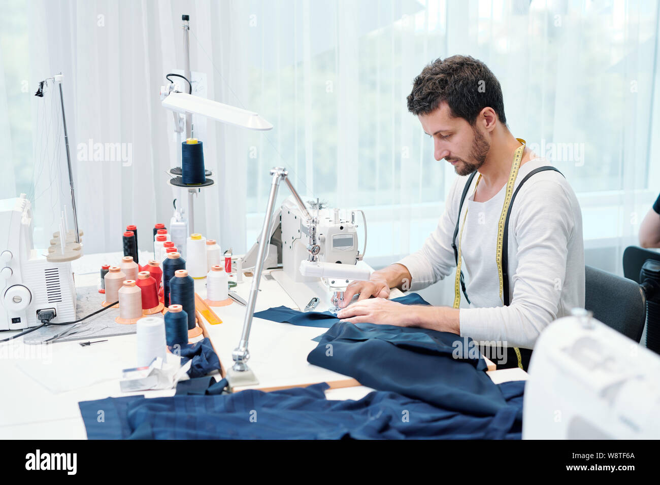 Man sitting at sewing machine hi-res stock photography and images - Alamy