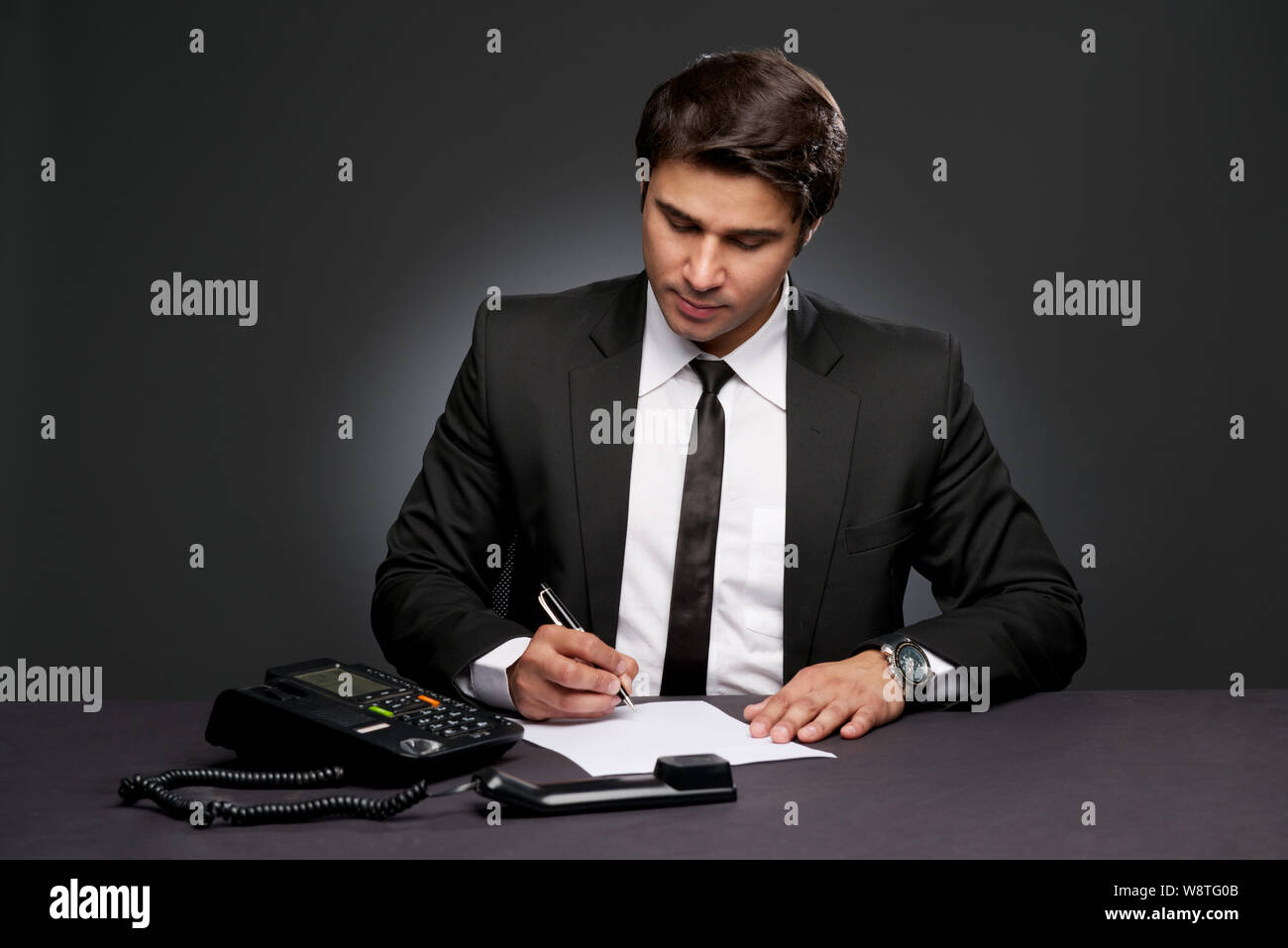 Document authority sitting writing looking down hi-res stock ...