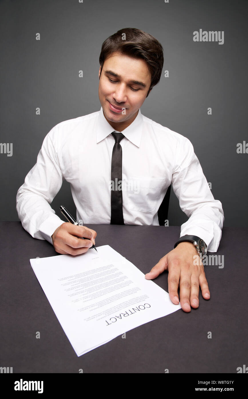 Indian businessman signing document hi-res stock photography and images ...