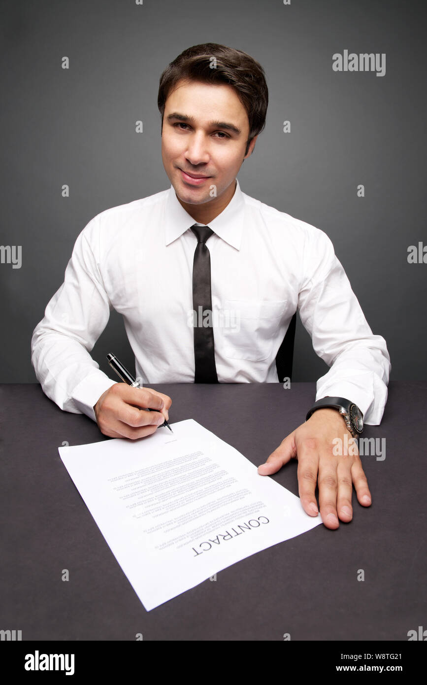 Indian businessman signing document hi-res stock photography and images ...