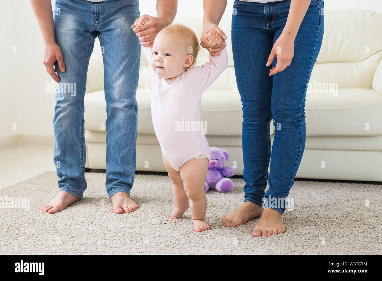 Family, children and parenthood concept - Parents teaching baby girl to ...