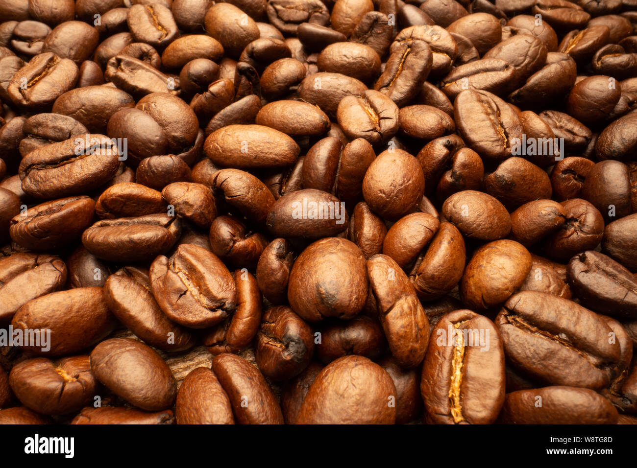 Very big roasted brown coffee beans background Stock Photo - Alamy