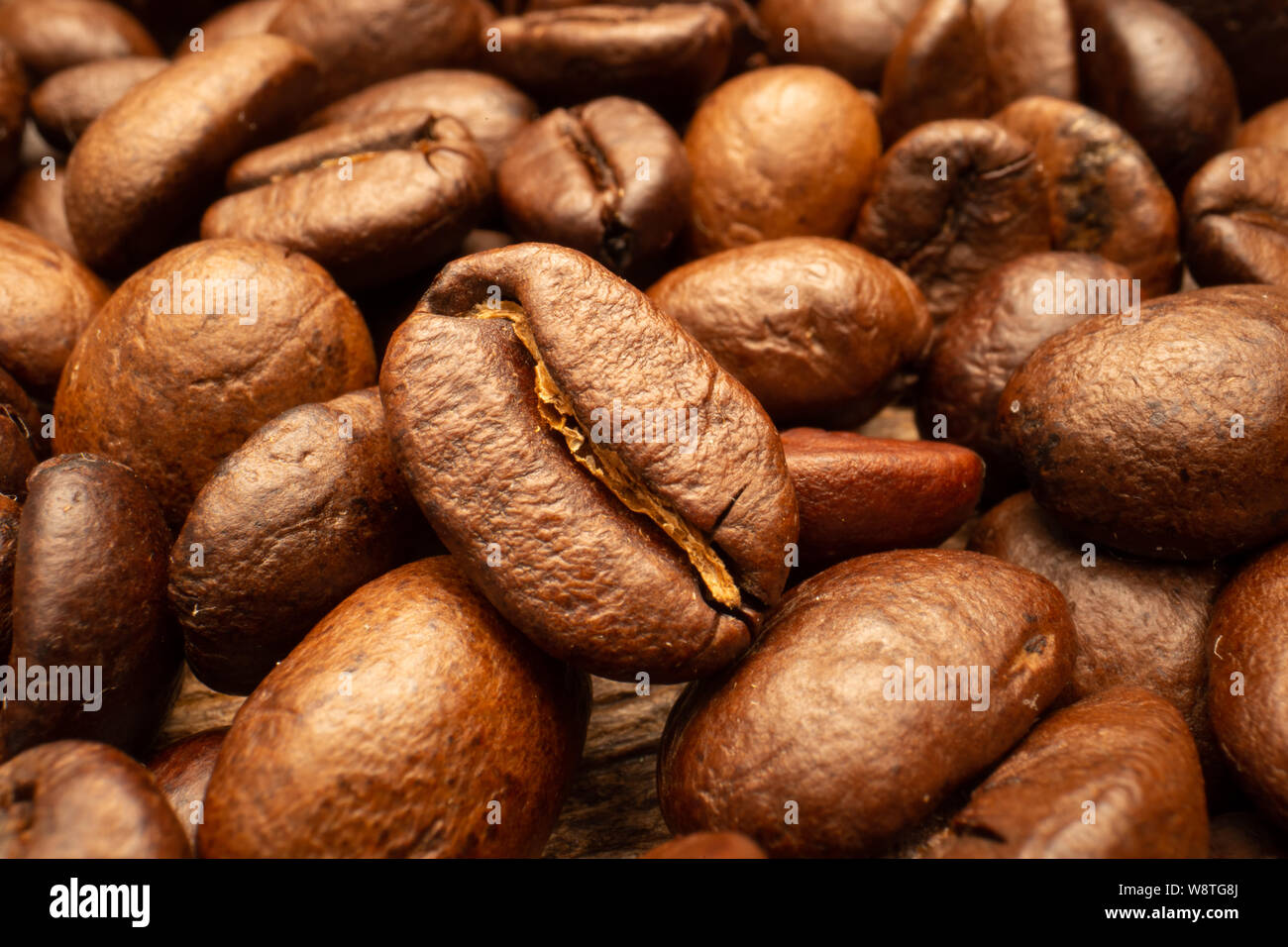 Very big roasted brown coffee beans background Stock Photo - Alamy