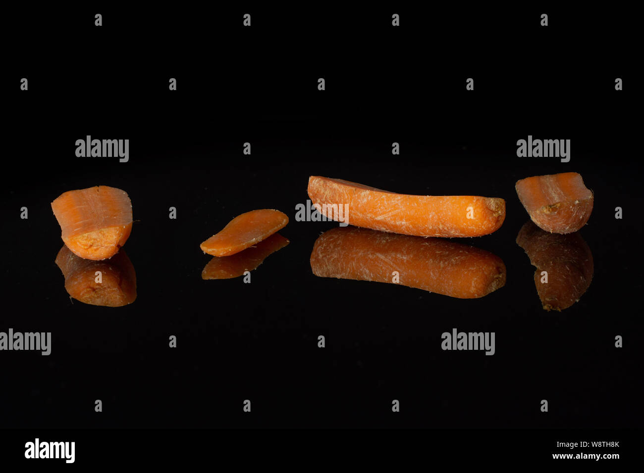 Group of four halves of stale orange stale baby carrot baby isolated on ...