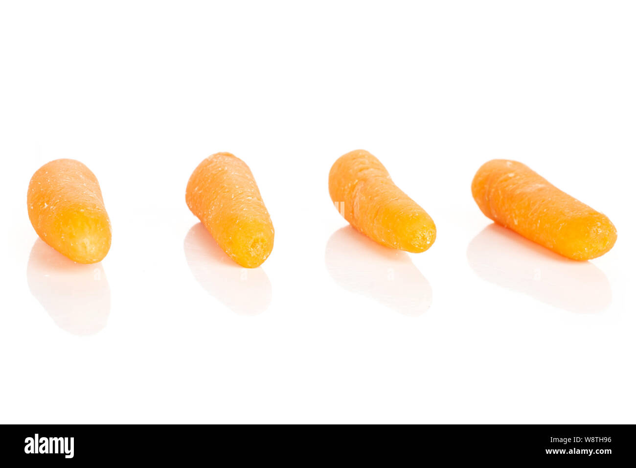 Group of four whole stale orange stale baby carrot baby isolated on ...