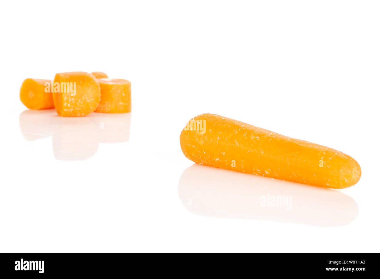 Group of one whole four quarters of stale orange stale baby carrot baby ...