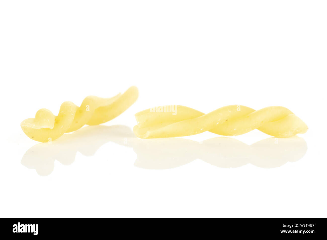 Group of two whole fresh raw pasta gemelli isolated on white background ...