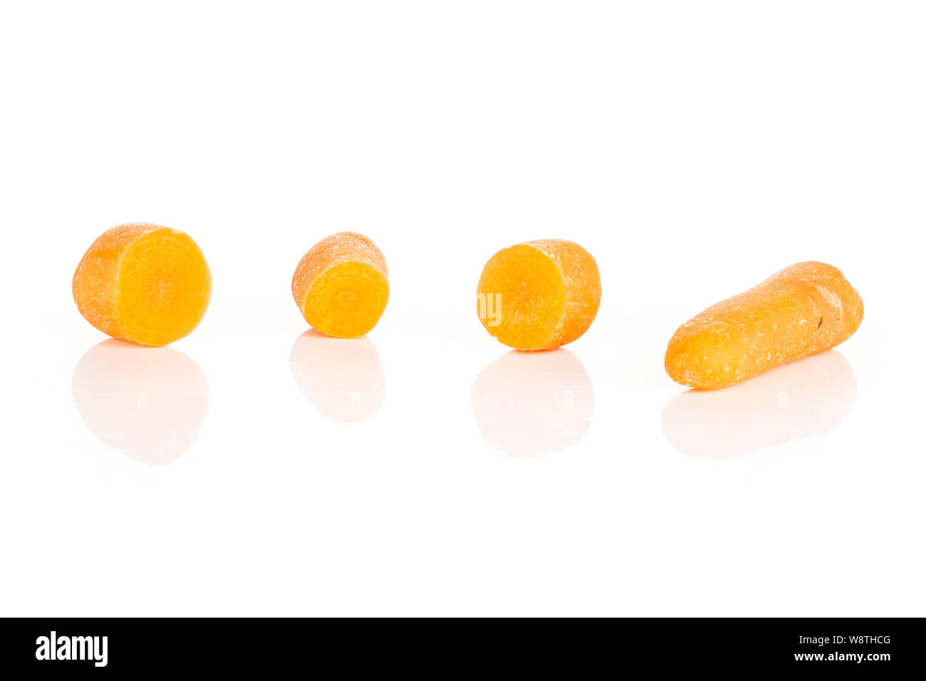 Group of one whole three halves of stale orange stale baby carrot baby ...