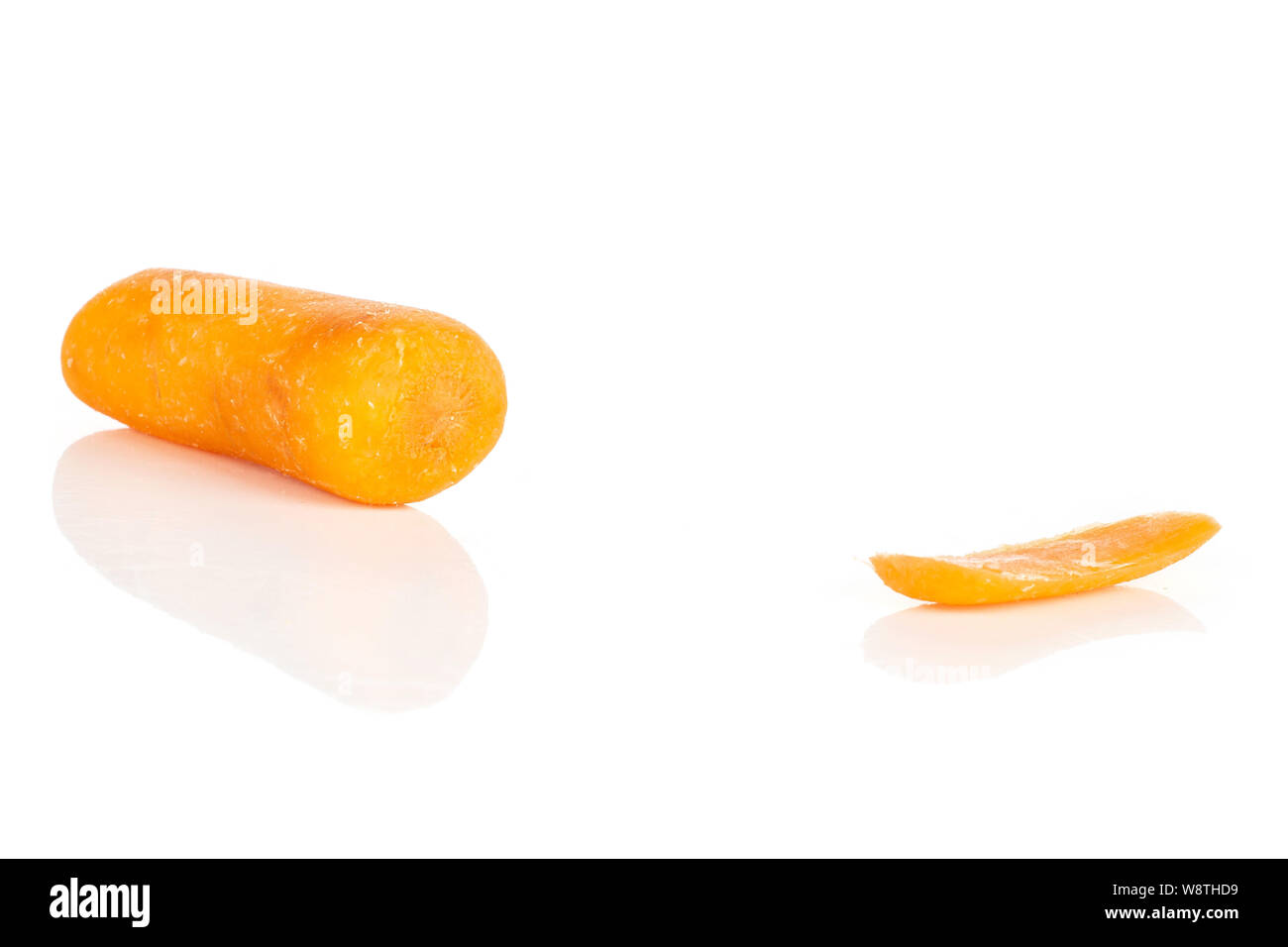 Group of one whole one half of stale orange stale baby carrot baby ...