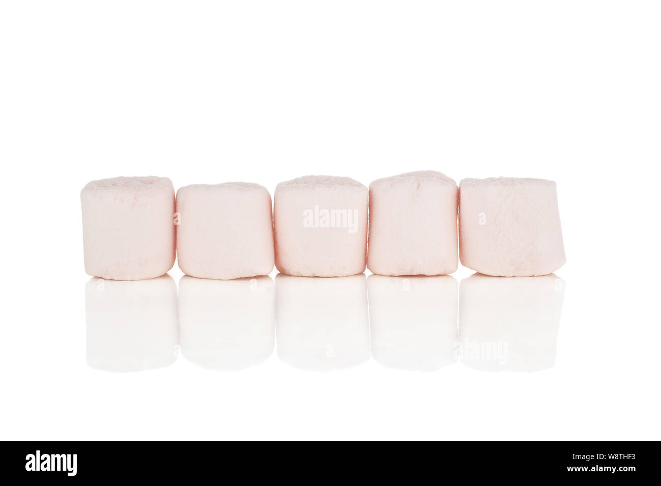 Group of five whole pink sweet fluffy marshmallow in row isolated on ...