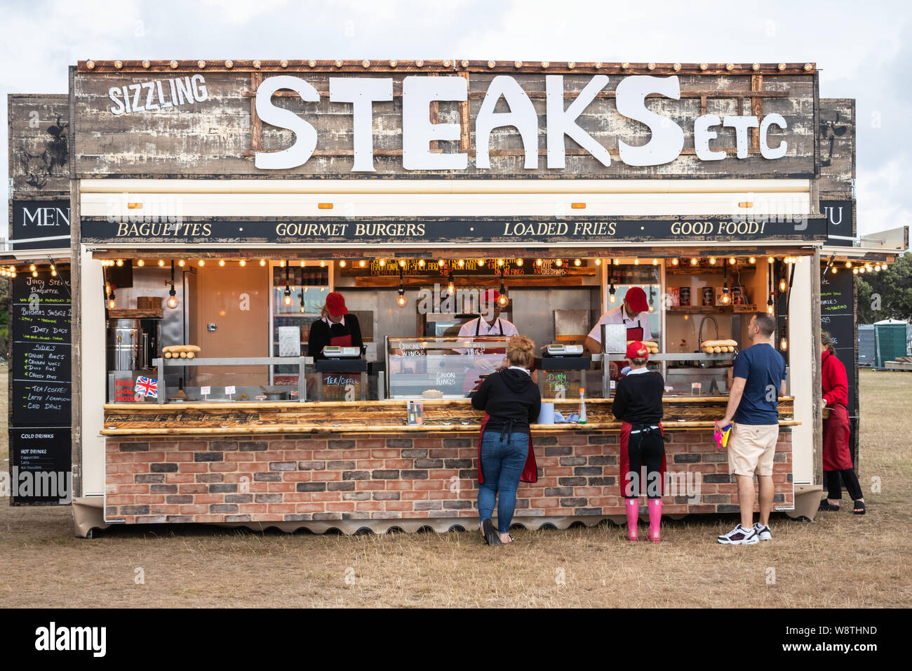 People queuing for food at an outdoor event or festival Stock Photo - Alamy