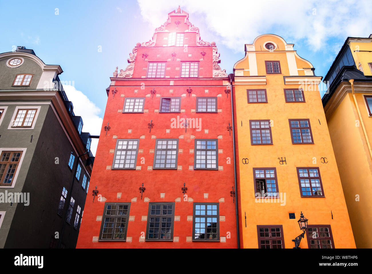 Part of the facade of a red brown historic building illuminated ...