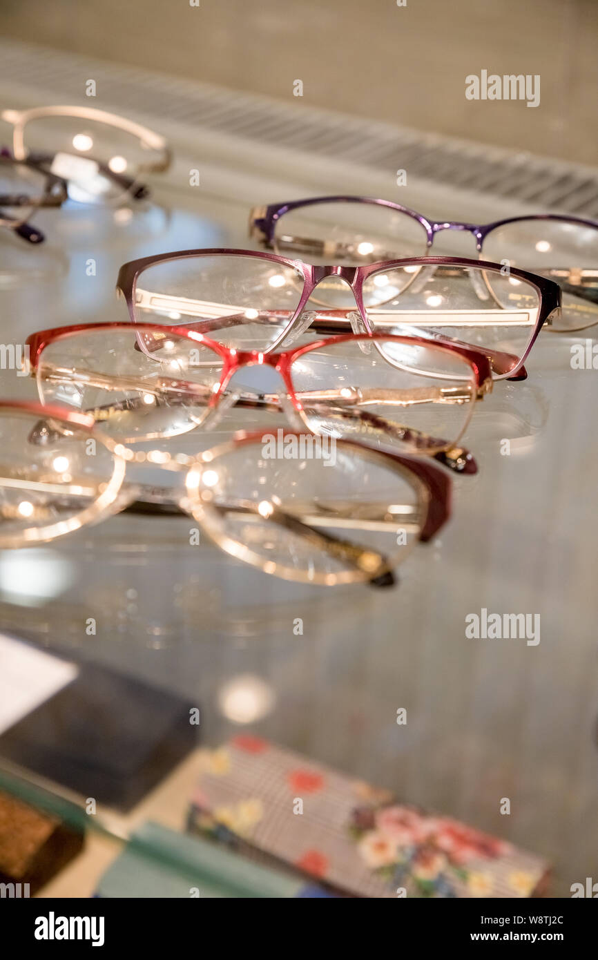 Many glasses rows at optical retail store. Rich assortment choice of ...