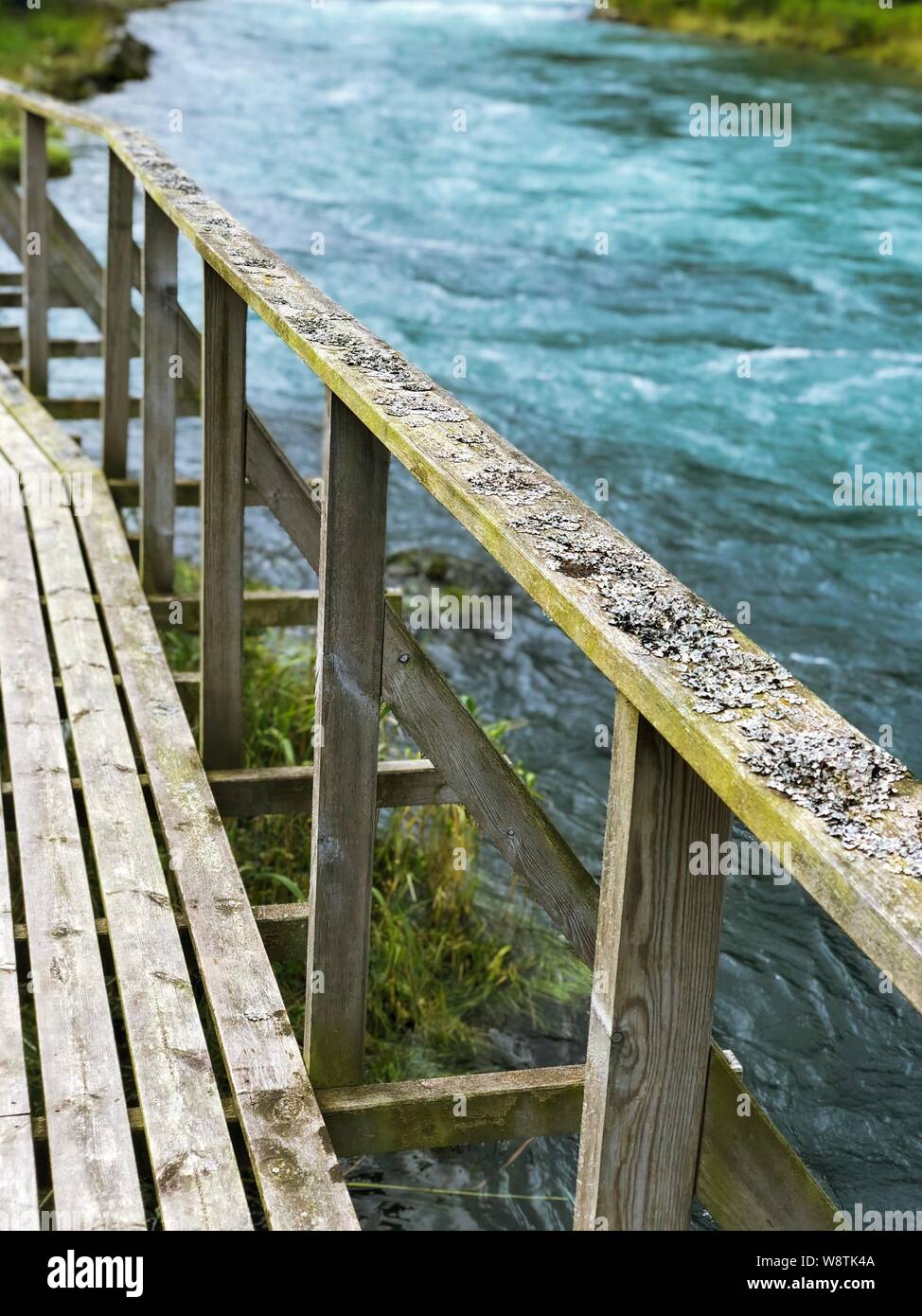 Old wooden textured river bridge with beautiful moss and turquoise ...
