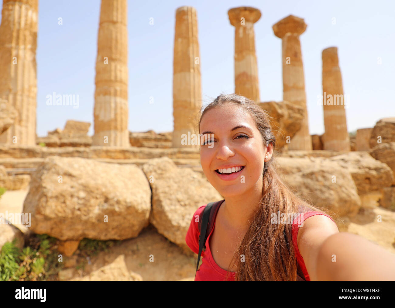 Happy smiling woman taking self portrait with greek temple on the ...
