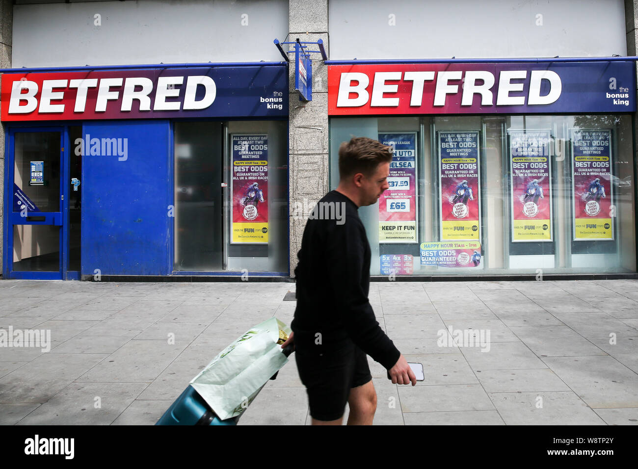 London, UK. 11th Aug, 2019. A man is seen walking past a branch of ...