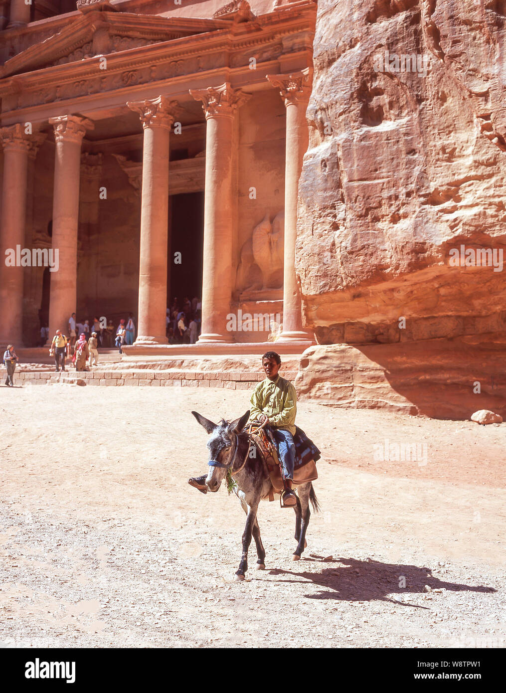 Boy riding donkey outside The Treasury (Al Khazneh), Ancient City of ...