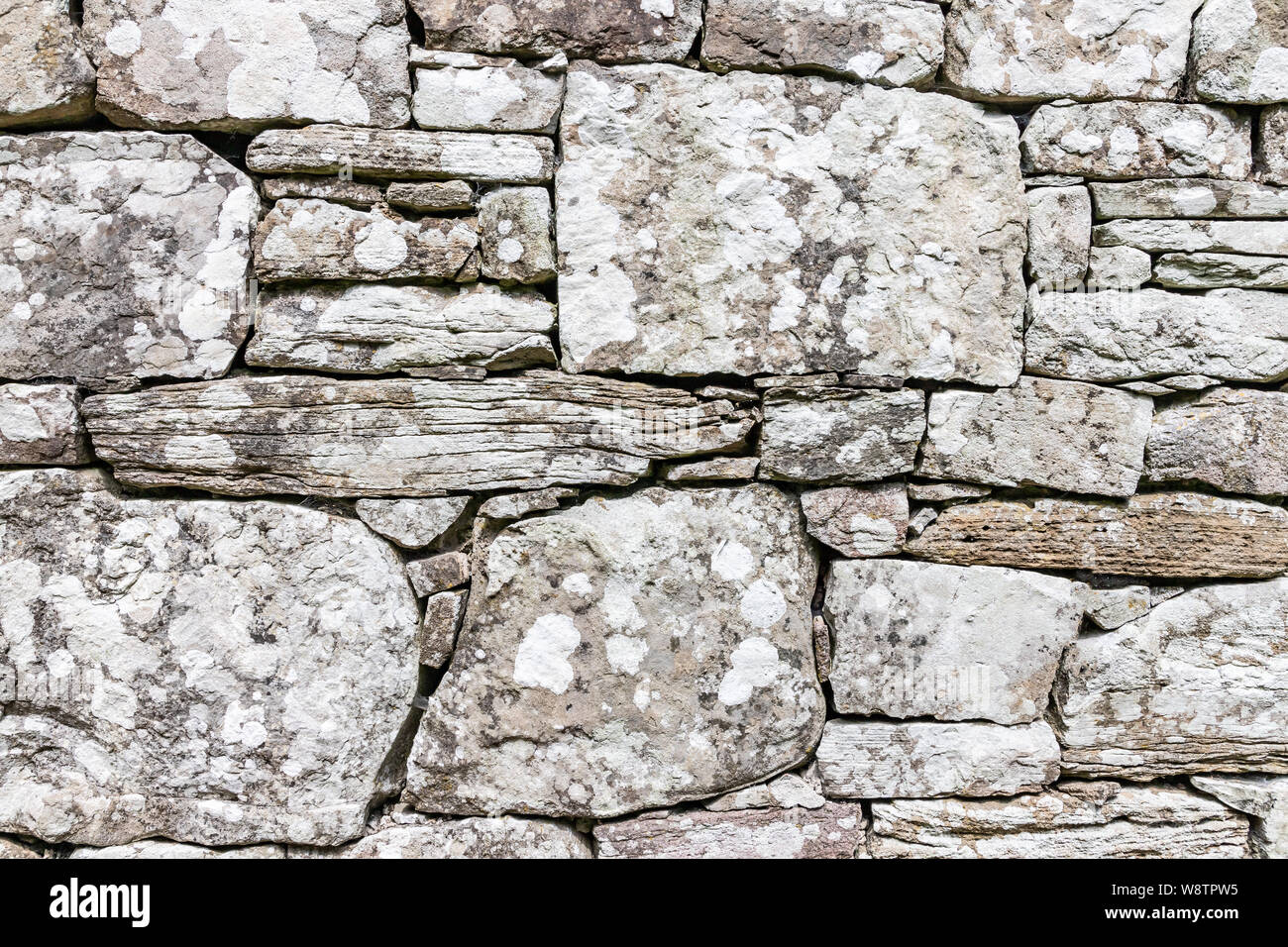 Rock stone gray and white ruins wall background Stock Photo - Alamy