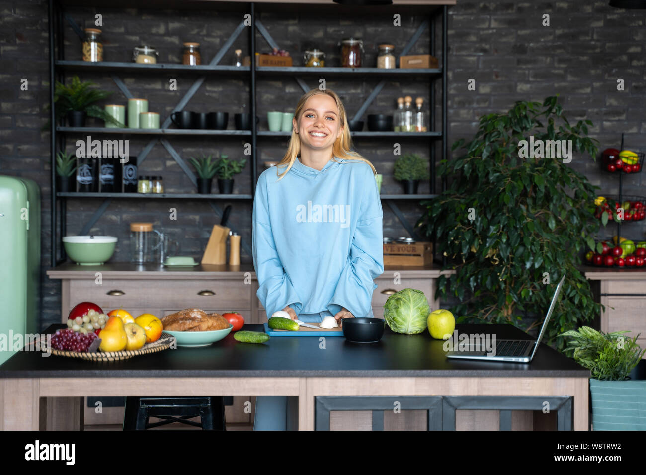 Beautiful young girl posing in the kitchen Stock Photo - Alamy