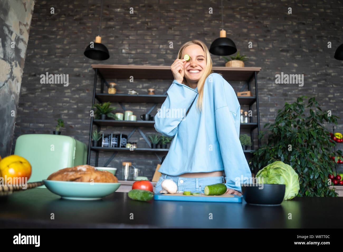 Beautiful young girl posing in the kitchen Stock Photo - Alamy