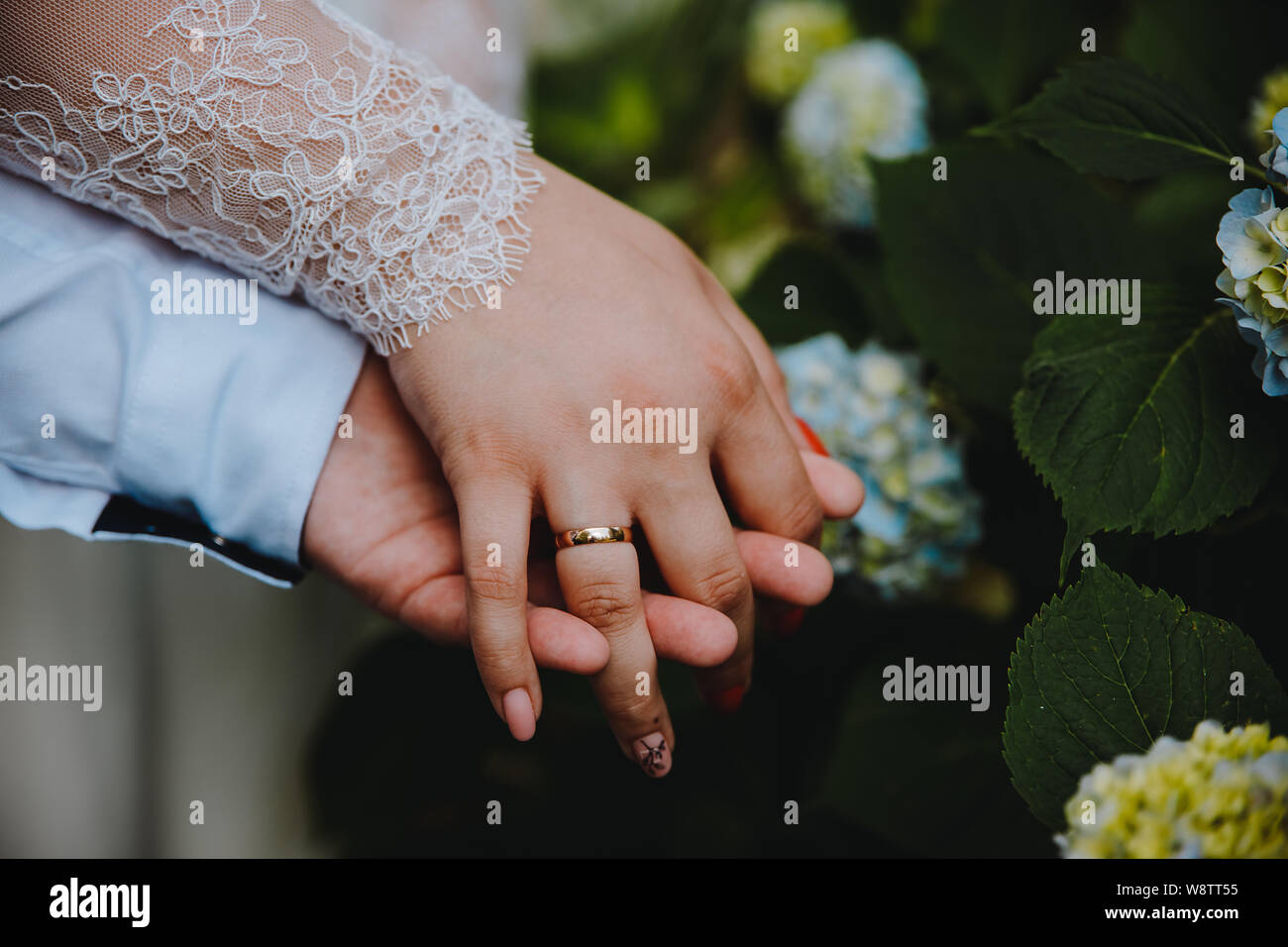 Young married couple holding hands, ceremony wedding day Stock Photo ...