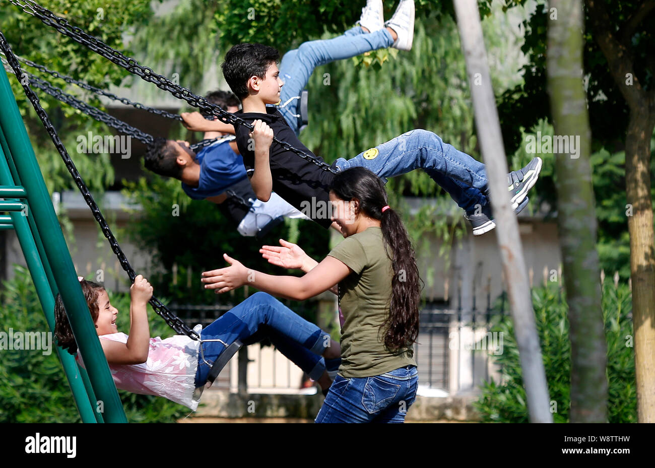 Beirut, Lebanon. 11th Aug, 2019. Children play on swings during the Eid ...