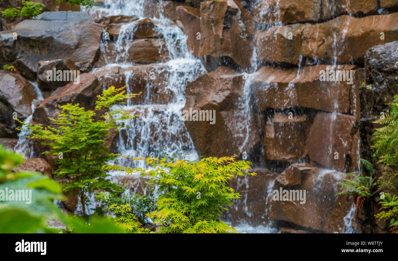 Indoor Garden Waterfall over Brown Stones Stock Photo - Alamy