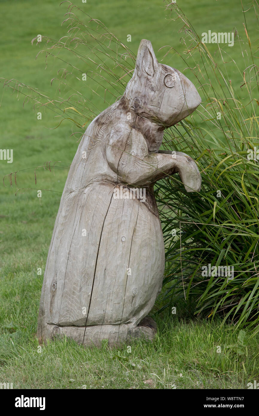 Giant carved wooden squirrel sitting in grass field, Cotswolds, UK ...
