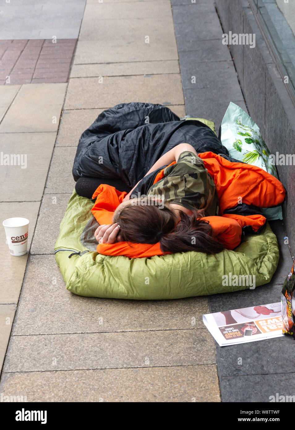 Homeless girl sleeping on the pavement, Portland Street, Manchester ...