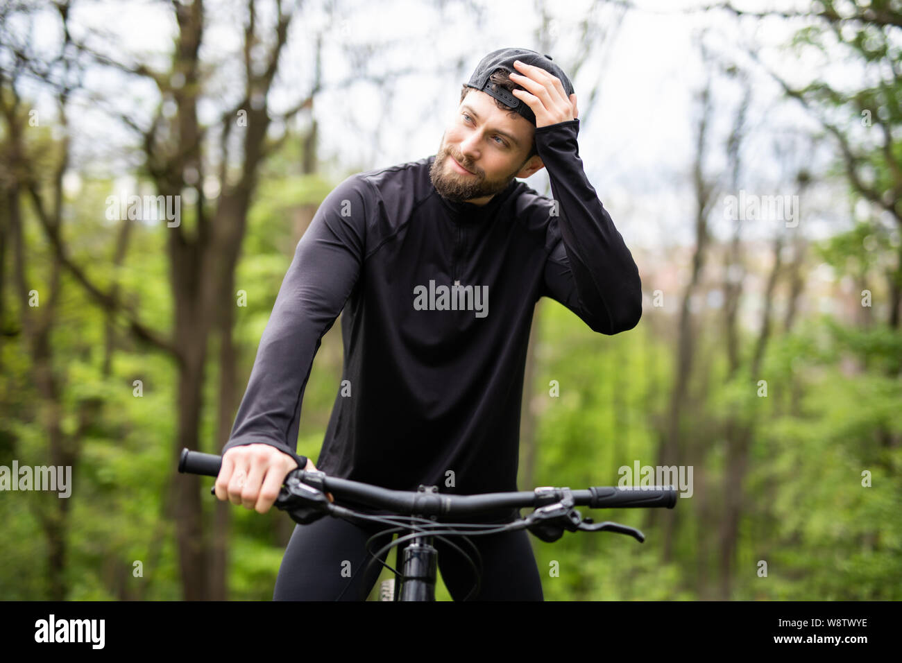 Professional mountain bike cyclist riding trail in forest, details of ...