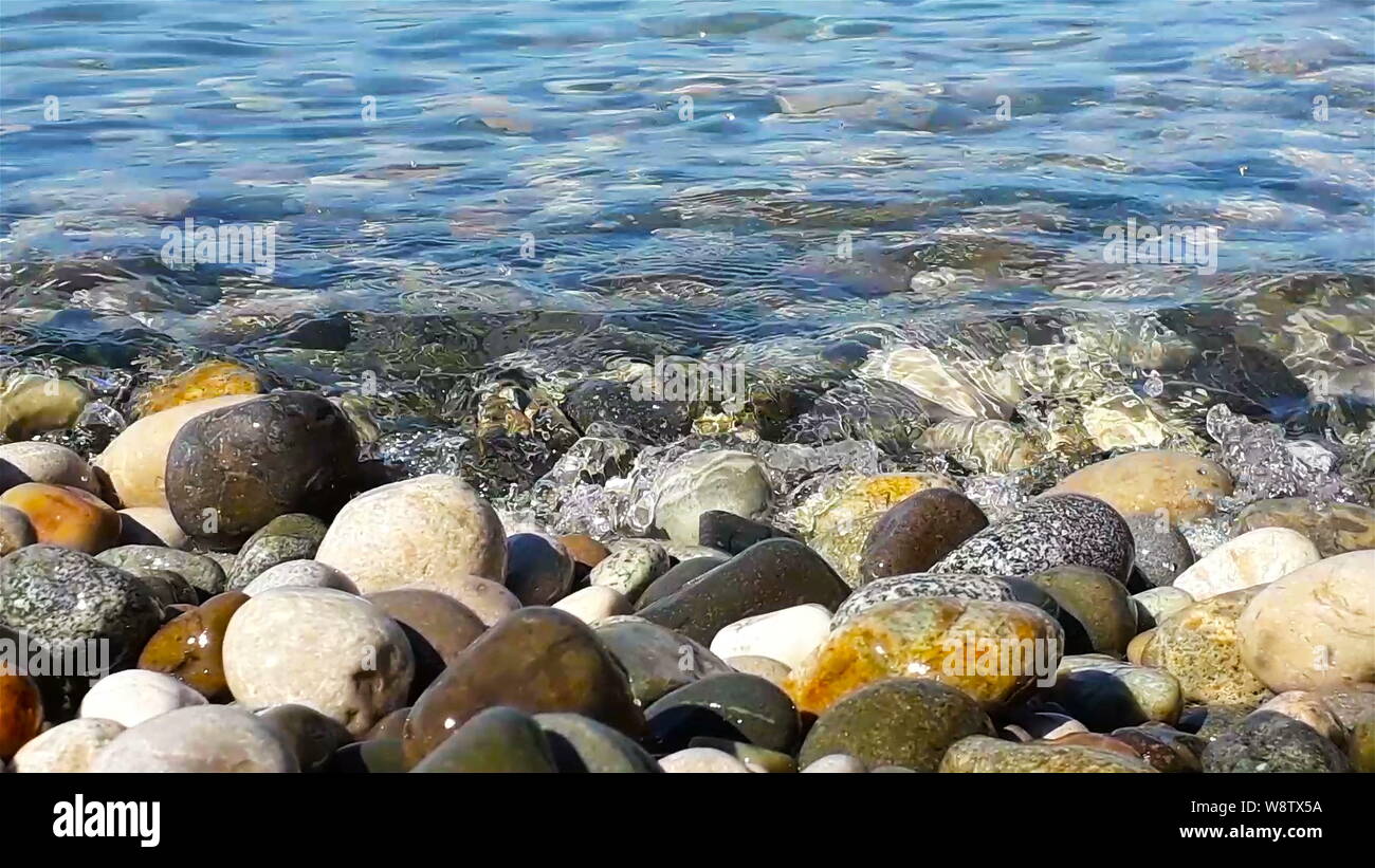 Pebble and sea water at sunny summer day, close up view Stock Photo - Alamy