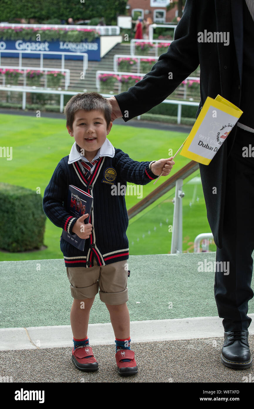 Ascot, UK. 10th August, 2019. Little boy Toby O'Shea waves a flag at ...