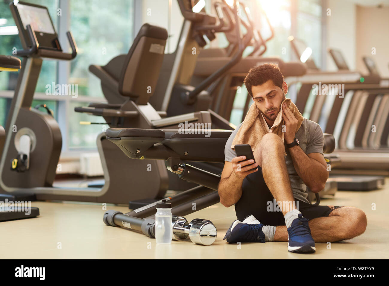 Muscular man sitting on floor hi-res stock photography and images - Alamy