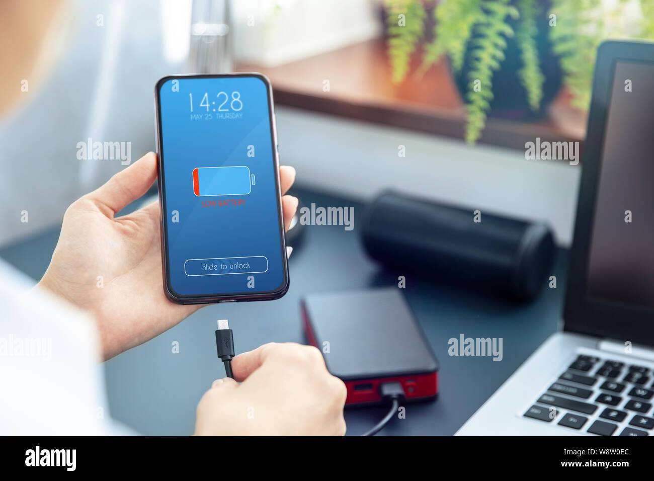 Woman charges her smartphone with power bank using fast charge USB-C ...