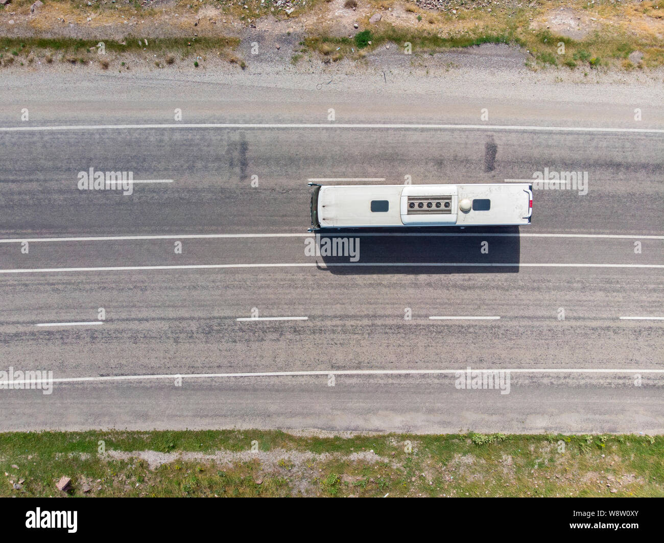 Aerial view of a bus on a high-speed road, with two lanes in each ...