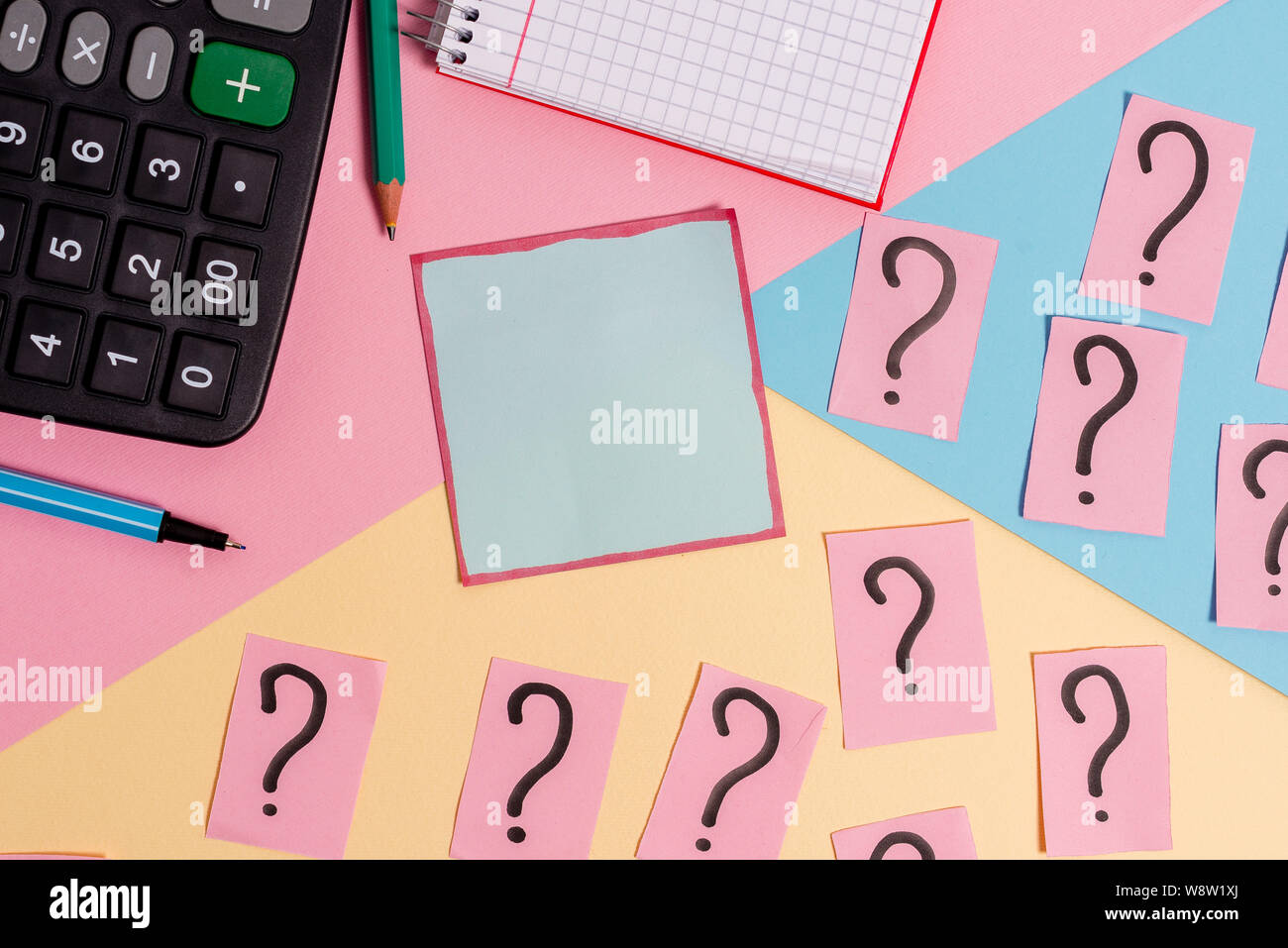 Mathematics stuff and writing equipment above pastel colours background ...