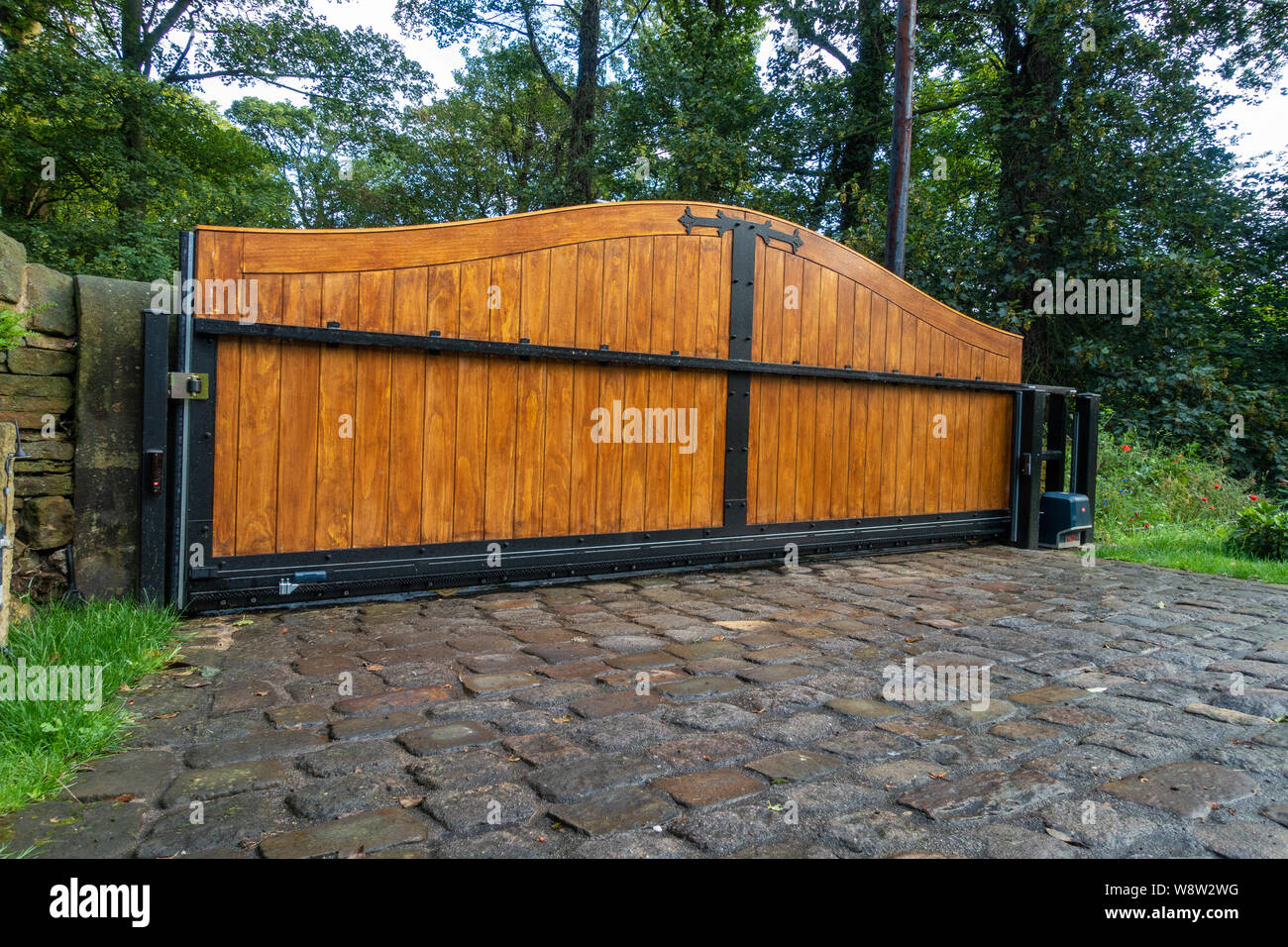 Rear view of very large electrically controlled wood gate opening Stock ...