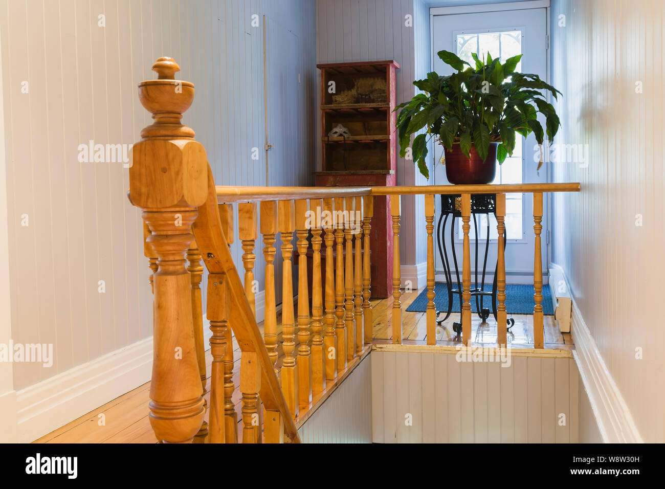 Pinewood post and staircase leading to downstairs floor inside an old ...