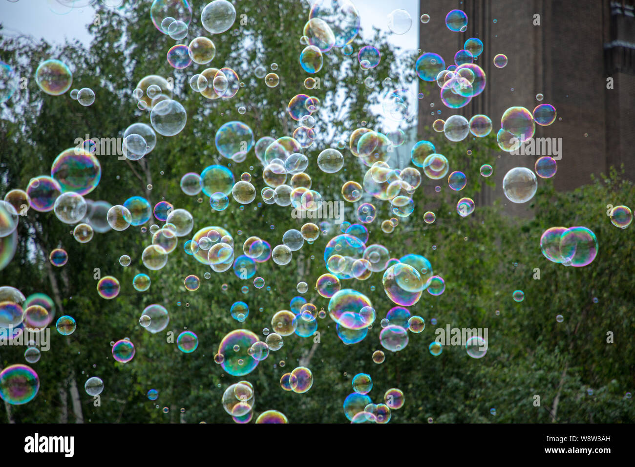Many small soap bubbles created with sticks and rope seen floating in ...