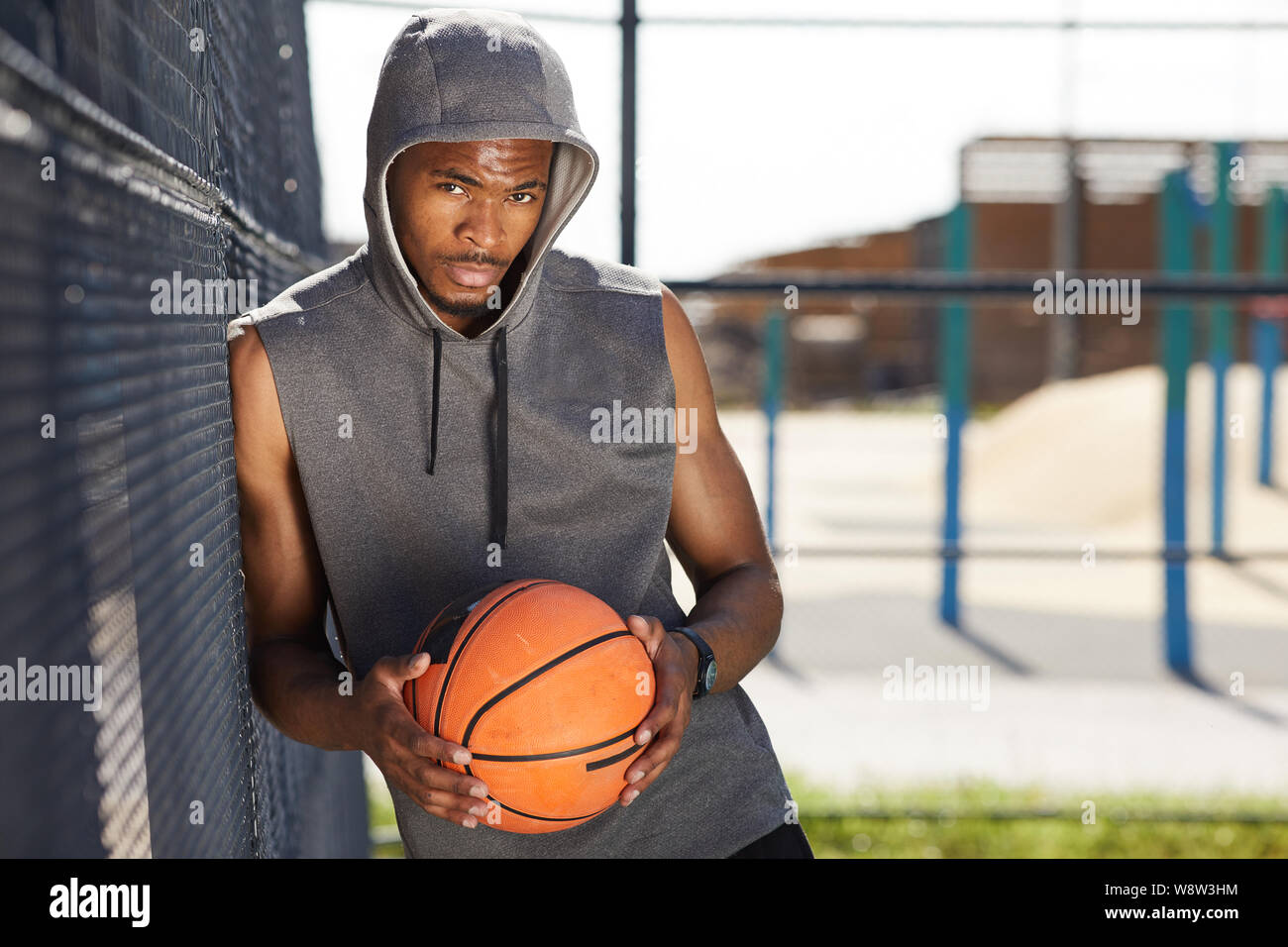 Waist up portrait of contemporary African-American man holding ...